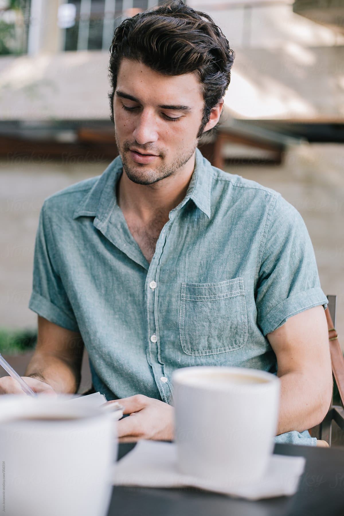 "Man Taking Notes On Business Meeting In A Coffee Shop" by Stocksy ...