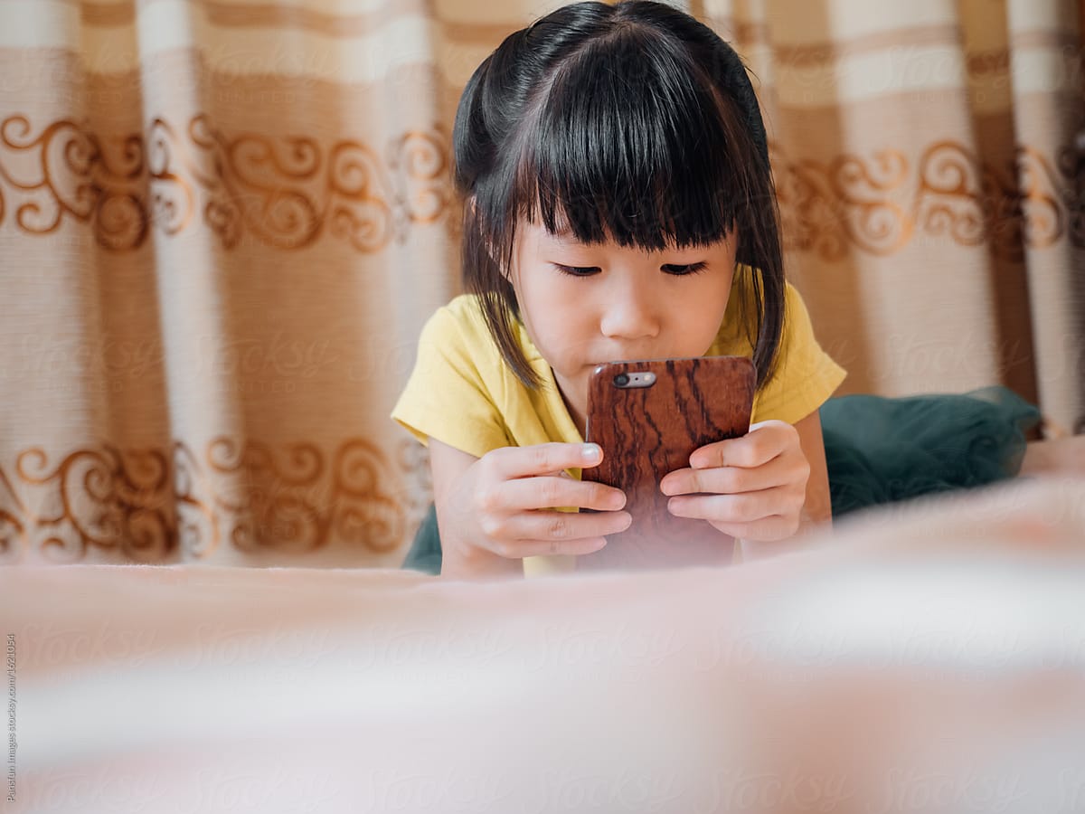 "Asian Little Girl Using Cell Phone" by Stocksy Contributor "Pansfun ...