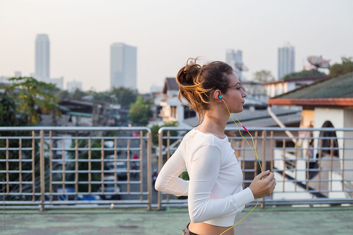 "Sport And Lifestyle Concept - Woman Running With Earphones" by Stocksy ...