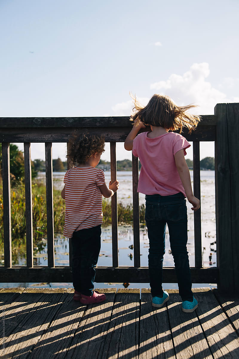 "Children On A Bridge" by Stocksy Contributor "Ali Lanenga" - Stocksy