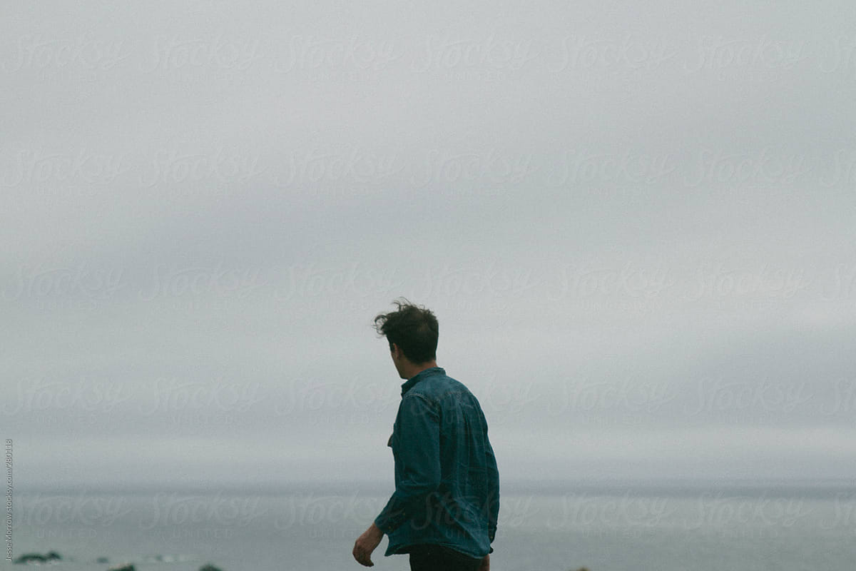 "Young Man Looks Out At Ocean" by Stocksy Contributor "Jesse Morrow ...