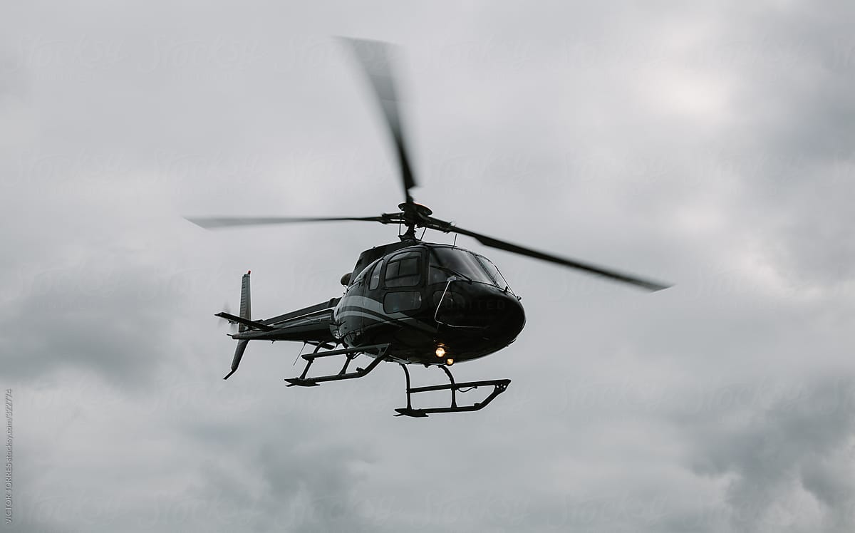 "Helicopter Flying In A Cloudy Sky" by Stocksy Contributor "VICTOR ...