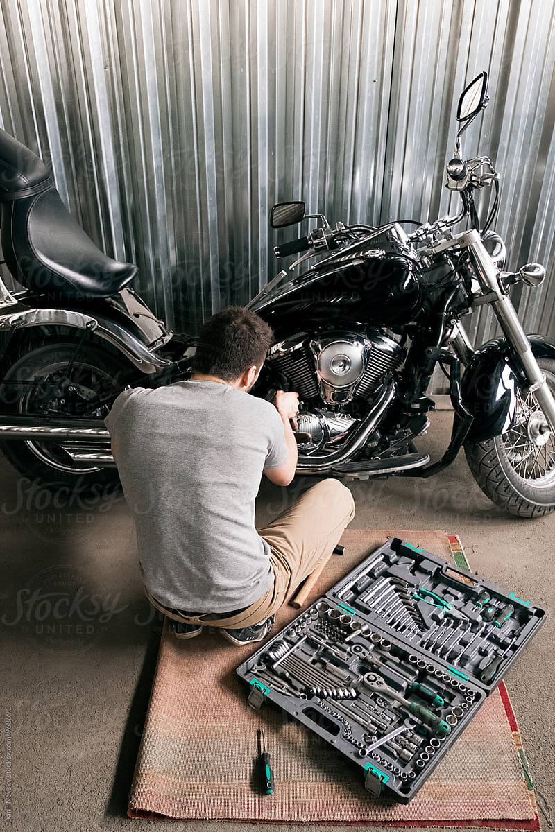 "Back View Of Man Reparing Motorcycle" by Stocksy Contributor "Danil ...