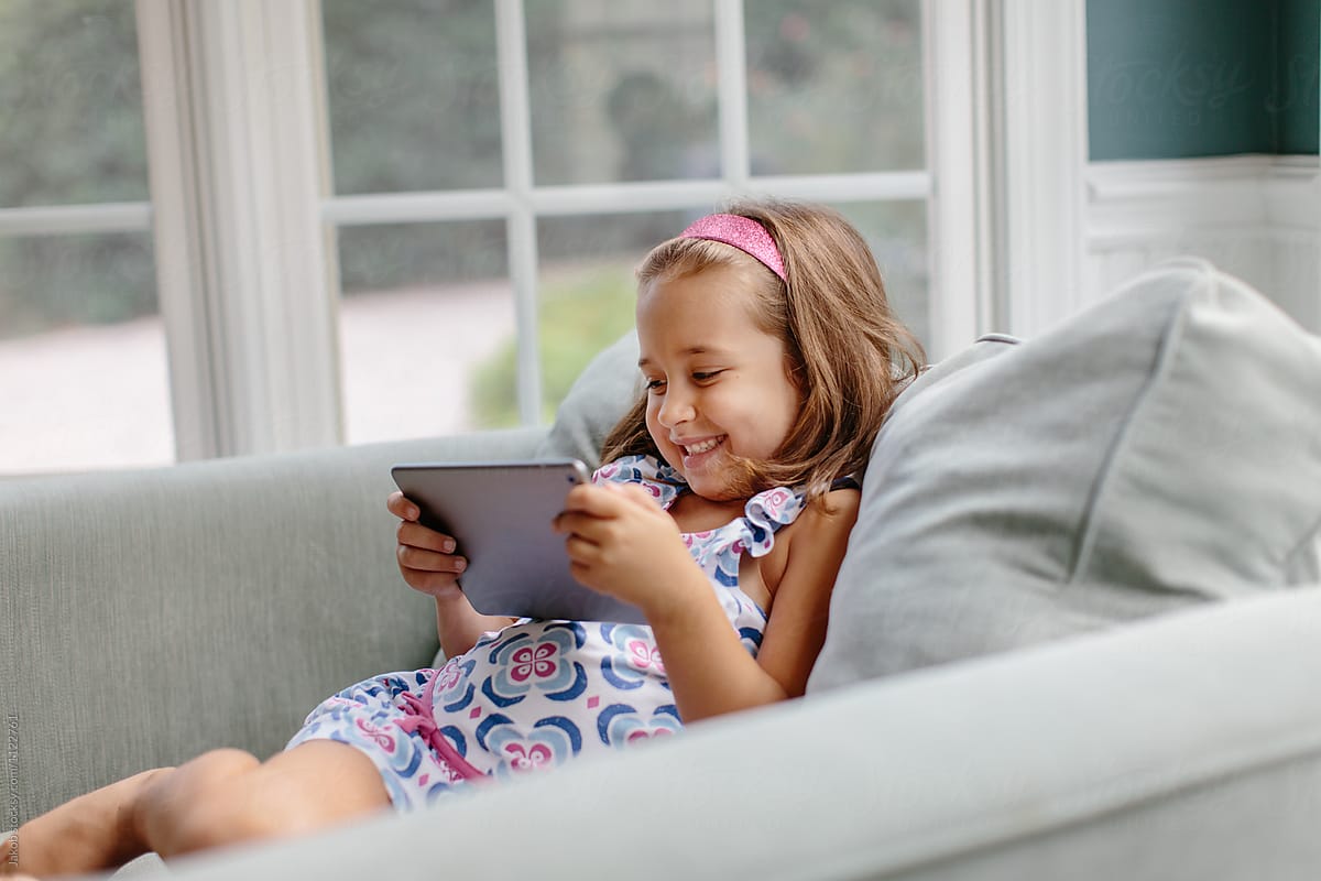 "Beautiful Young Girl Using A Tablet At Home" by Stocksy Contributor ...
