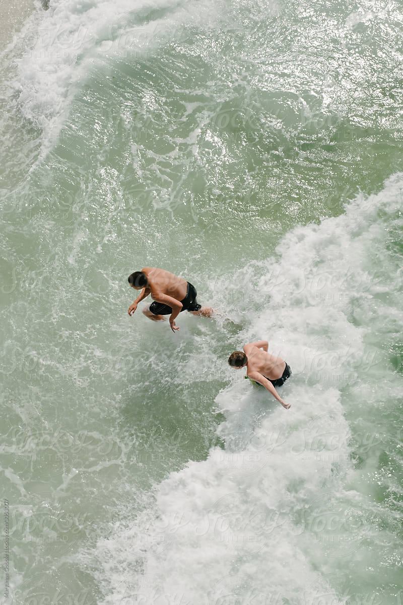 "Kids Playing In Ocean" by Stocksy Contributor "Maryanne Gobble" - Stocksy