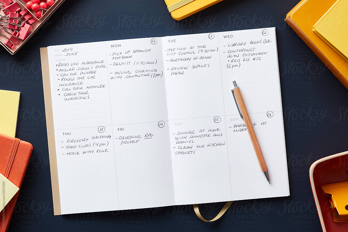 "Planner With Notes On Blue Desk" by Stocksy Contributor "Martí Sans ...