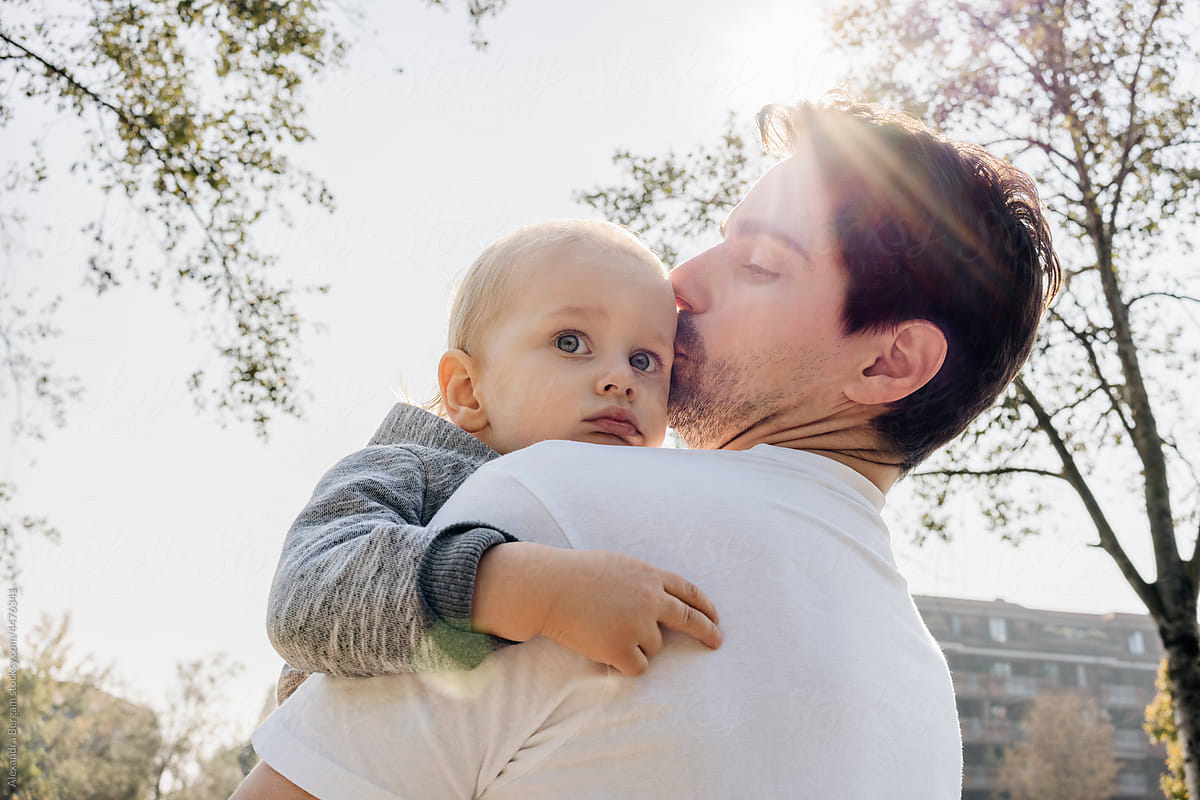 "Father Carries And Kisses The Baby Son On The Head" by Stocksy ...