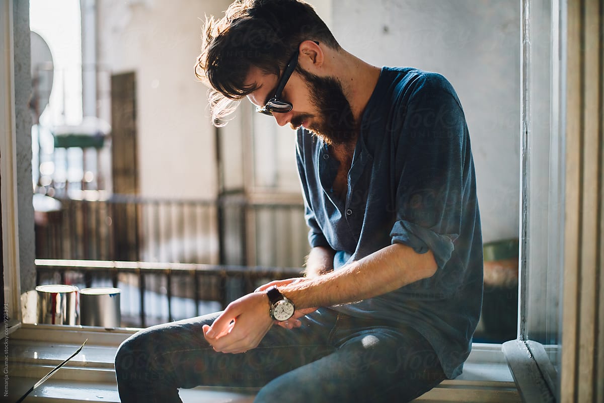 "Stylish Man Sitting On A Window" by Stocksy Contributor "Nemanja ...