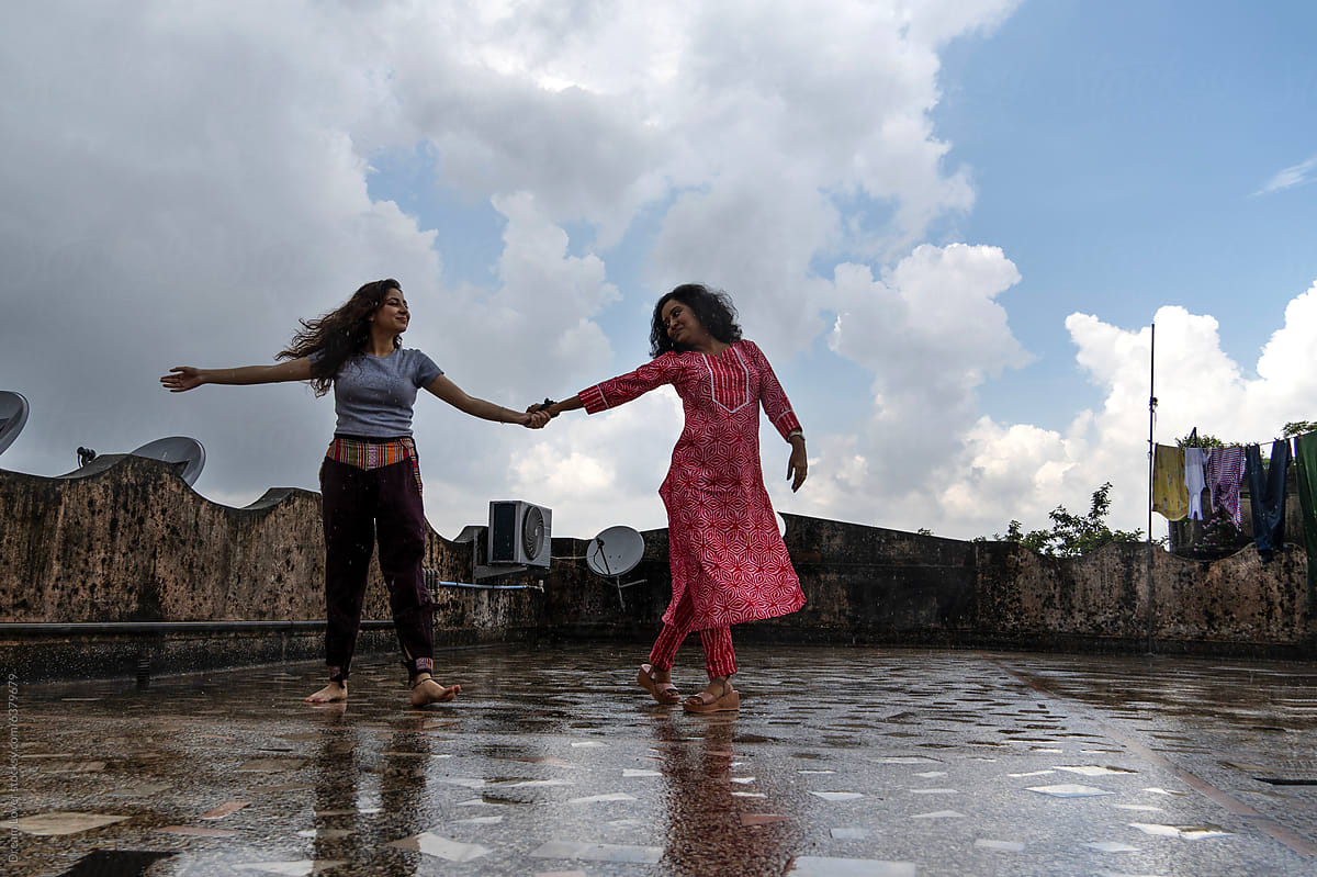 "Two Friends Enjoying Rain At Rooftop In Monsoon Season At Outdoors" by ...