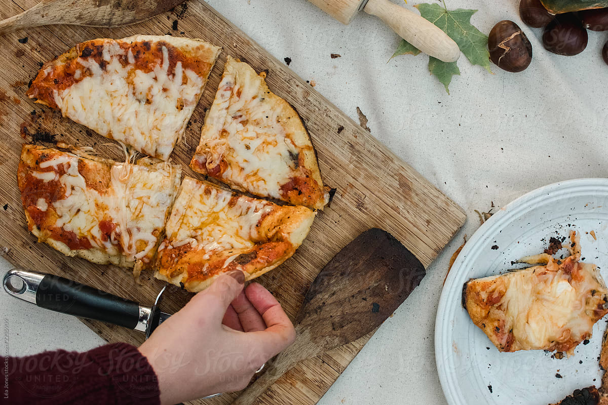 "Pizza Cooked On A Fire Pit" by Stocksy Contributor "Lea Jones" - Stocksy