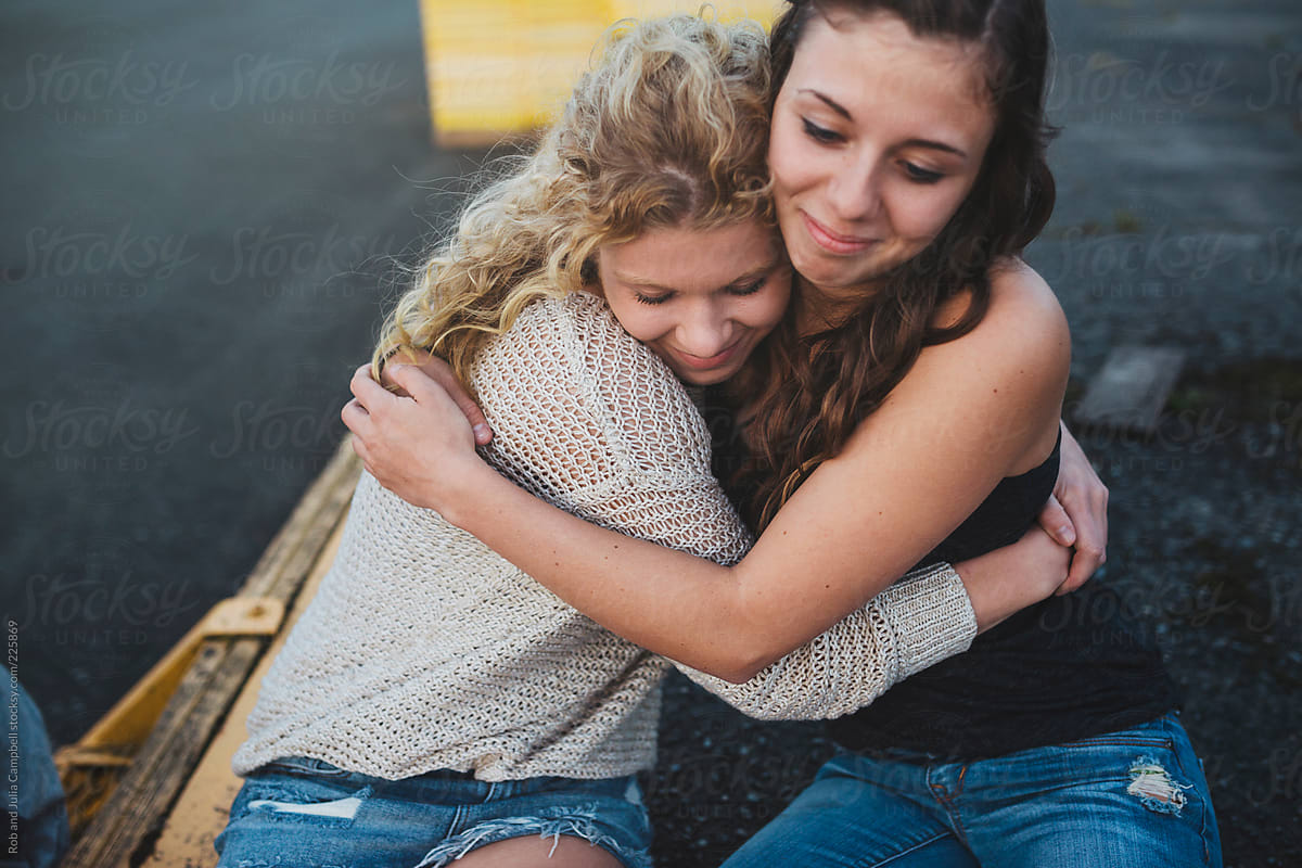  Two Pretty Teenage Girls Hugging Together Outside Saying Goodbye