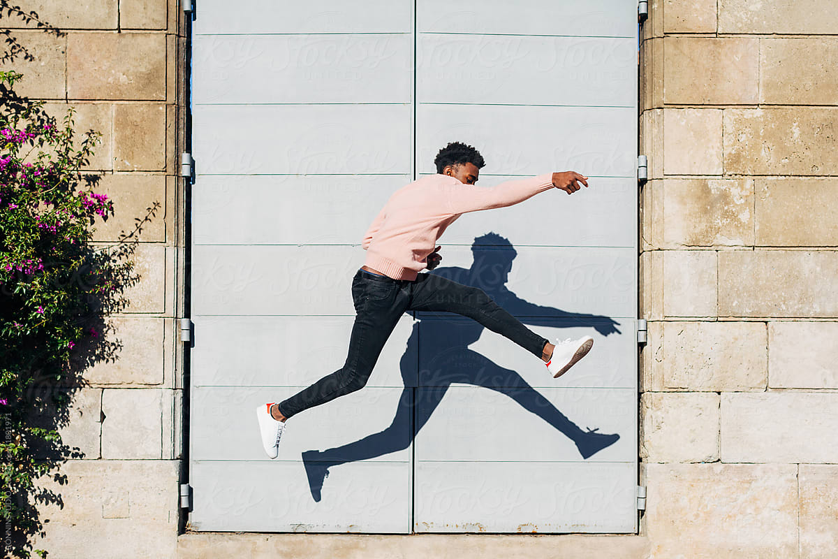 "Side View Of A Young Man Jumping On The Street." by Stocksy ...