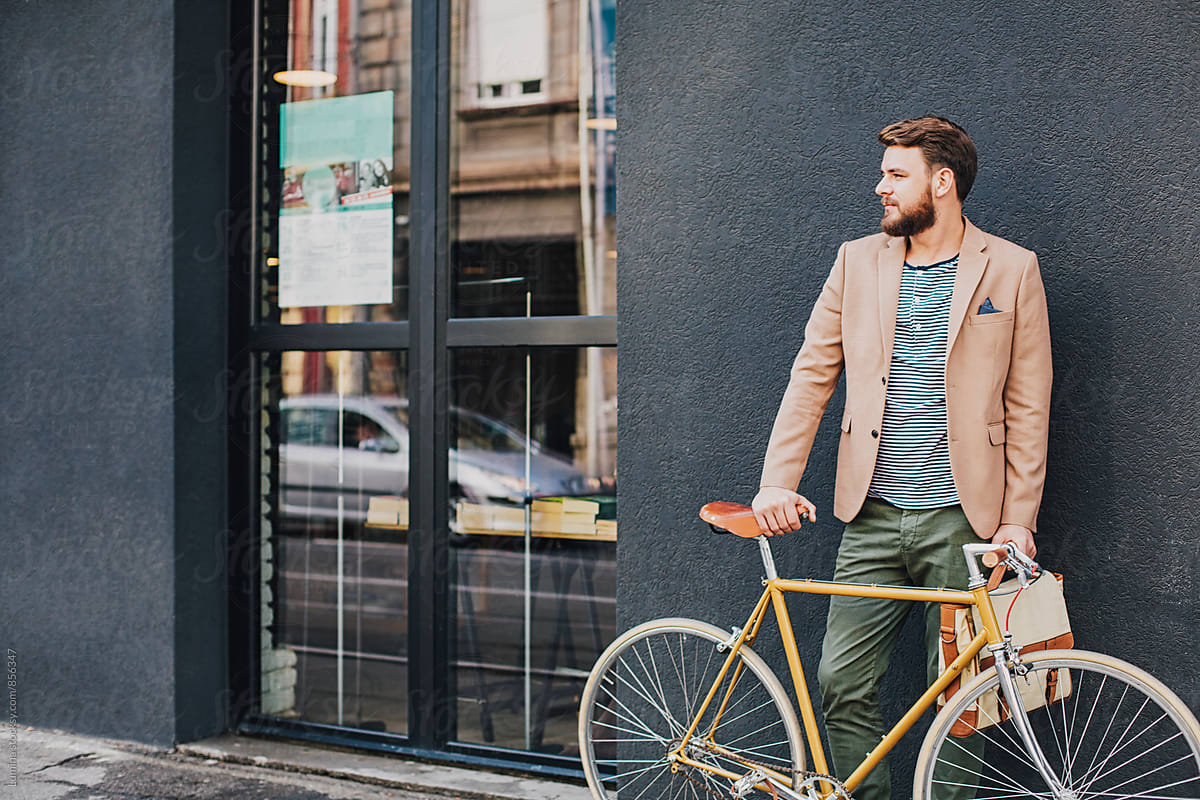 "Man With A Bike On The Street" by Stocksy Contributor "Lumina" - Stocksy