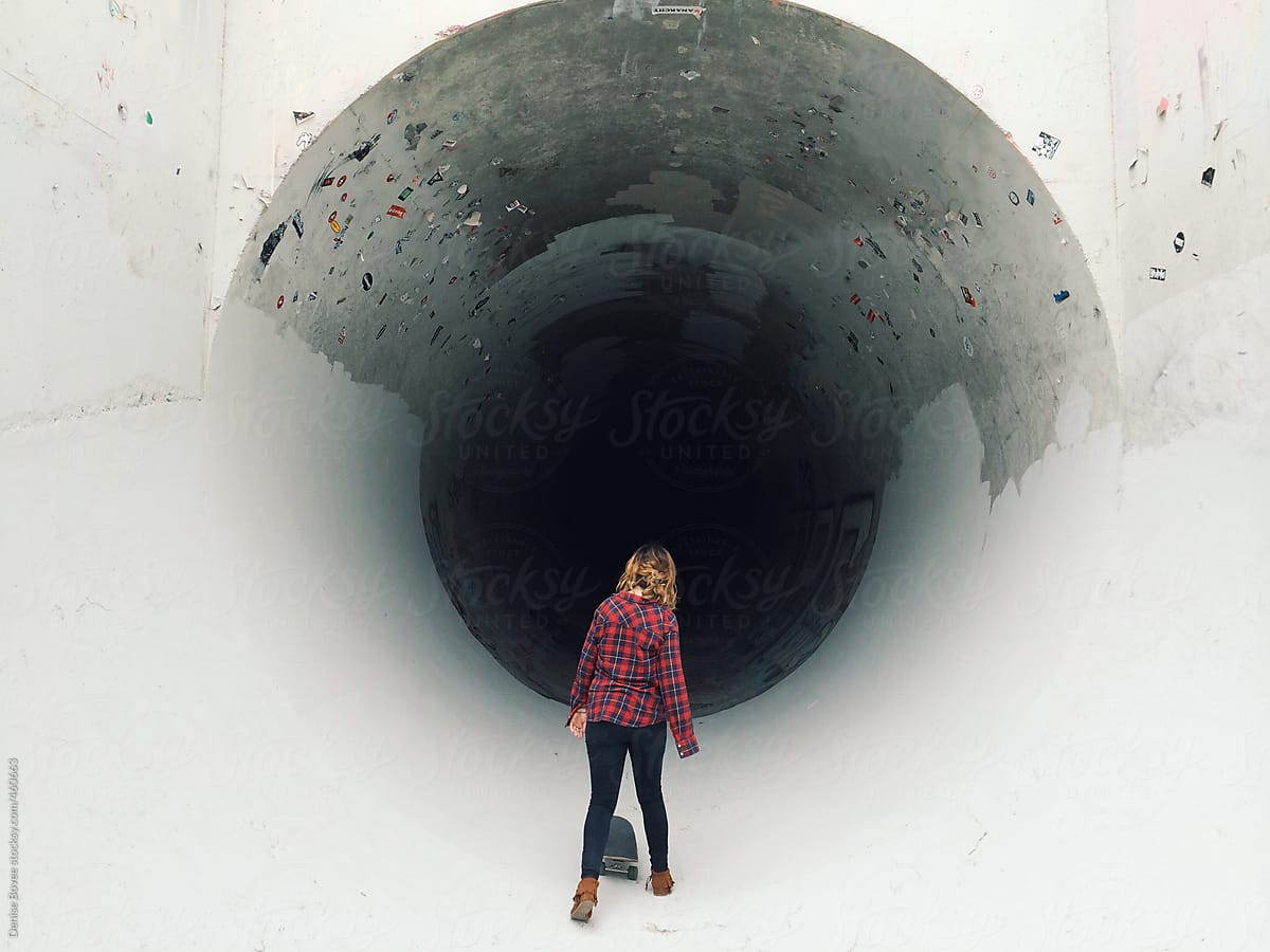 "Woman Walking Into Large Pipe" by Stocksy Contributor "Denise Bovee ...