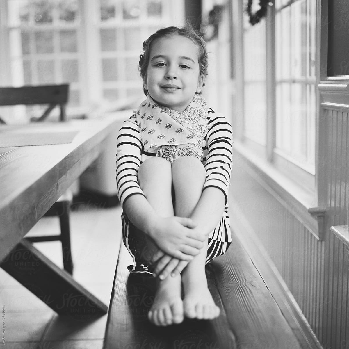 Cute Young Girl Holding Her Legs Sitting On A Bench By Stocksy Cute Young Girl Holding Her Legs Sitting On A Bench By Stocksy