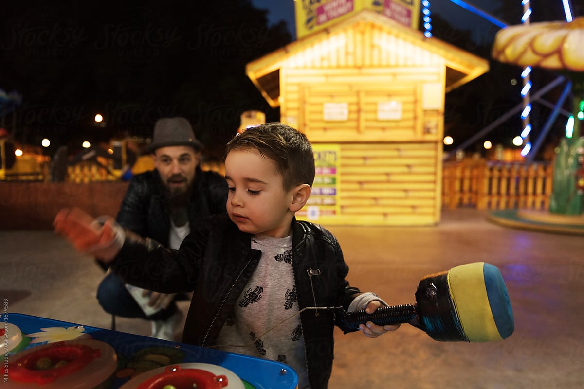 "Father And Son Playing On Fair" by Stocksy Contributor "Milles Team ...