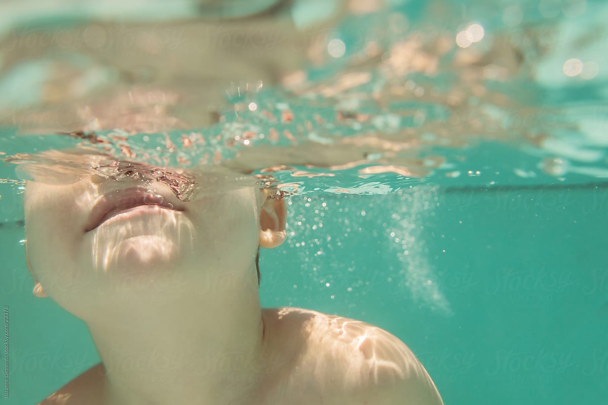 "Underwater Smile In The Pool" by Stocksy Contributor "SKC" - Stocksy