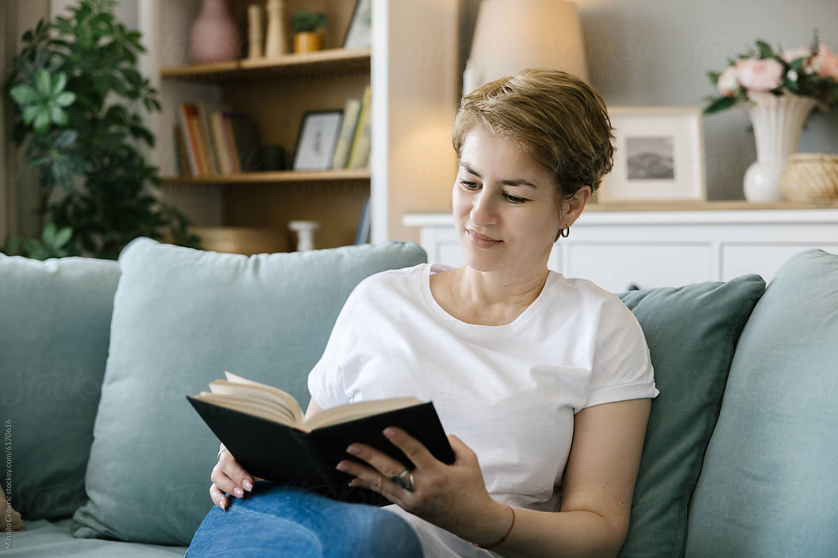 "Happy Woman Reading A Book" by Stocksy Contributor "Mihajlo Ckovric ...