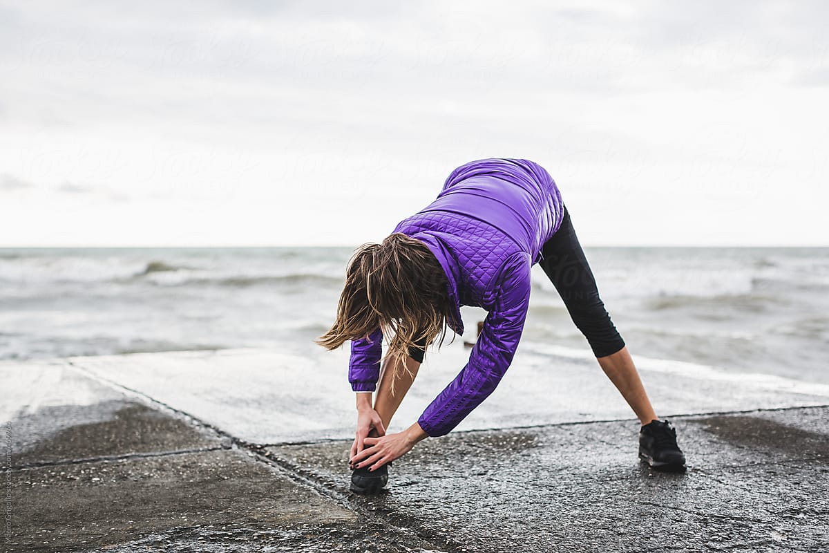 "Woman Doing Stretching By The Sea" by Stocksy Contributor "Mauro ...