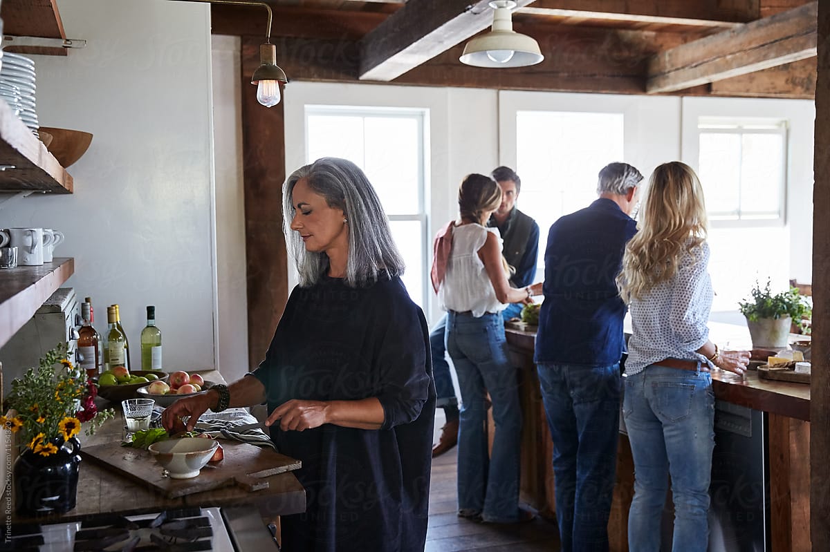 "Family And Friends Cooking Together In Rustic Farmhouse Kitchen" by ...