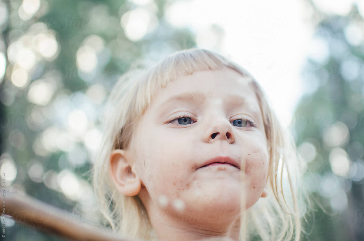 "Little Girl With Crooked Fringe Looking At Plant" by Stocksy ...
