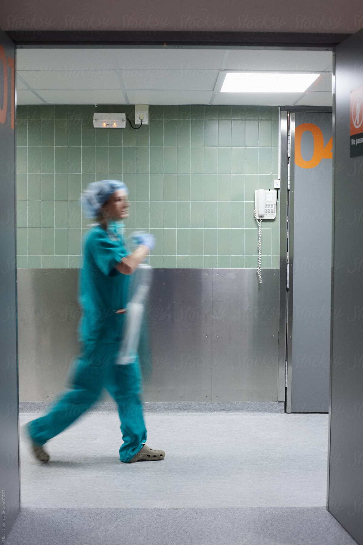 "Anonymous Healthcare Worker Walking By A Hospital Corridor" by Stocksy ...