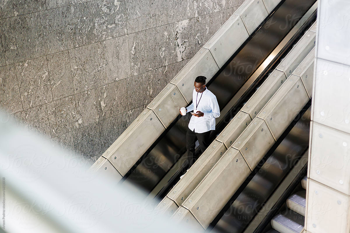 "Professional Man Descending In Urban Building With Coffee And Phone ...