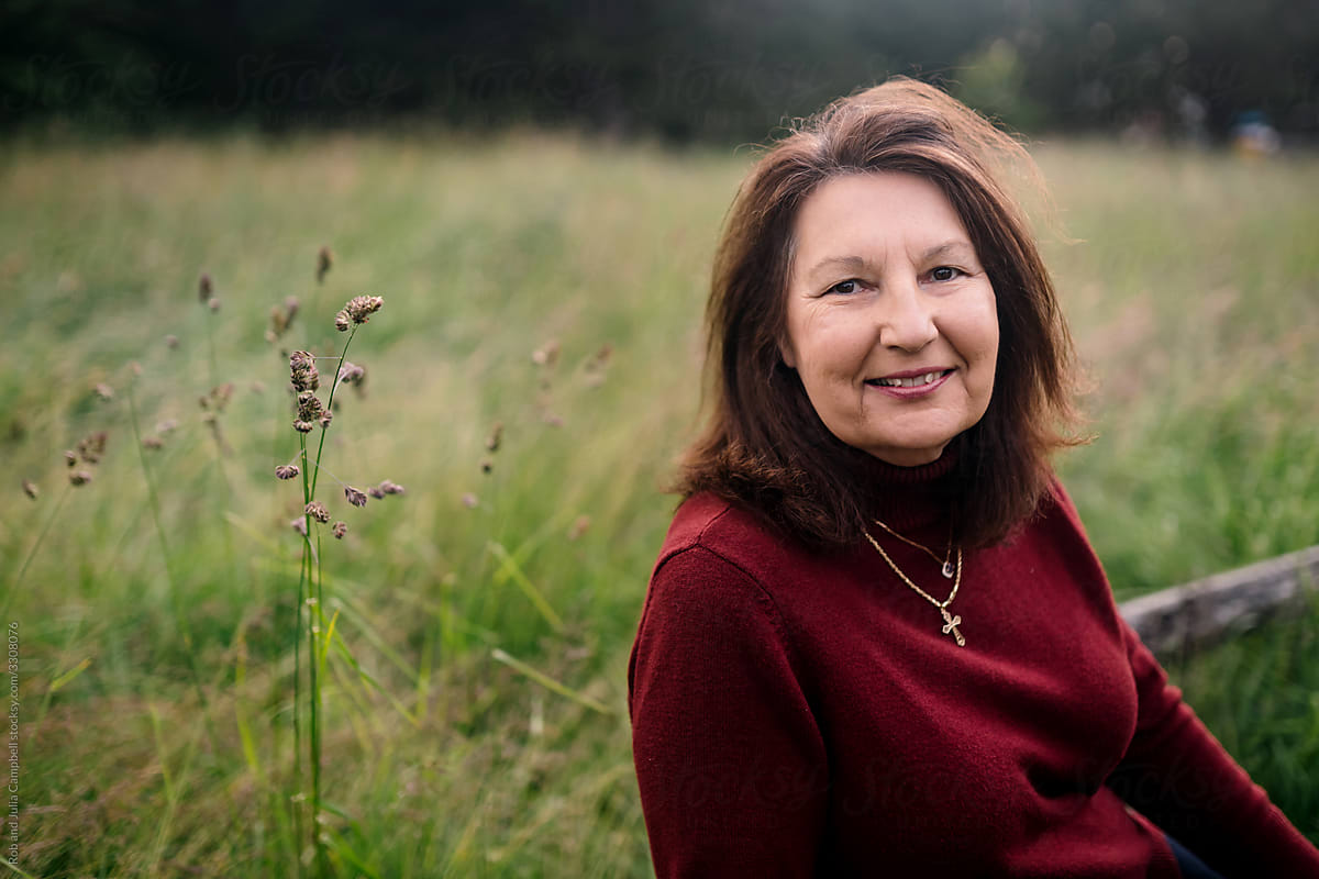 "Portrait Of Older, Warm, Happy Woman Outside Sitting On Fence." by ...