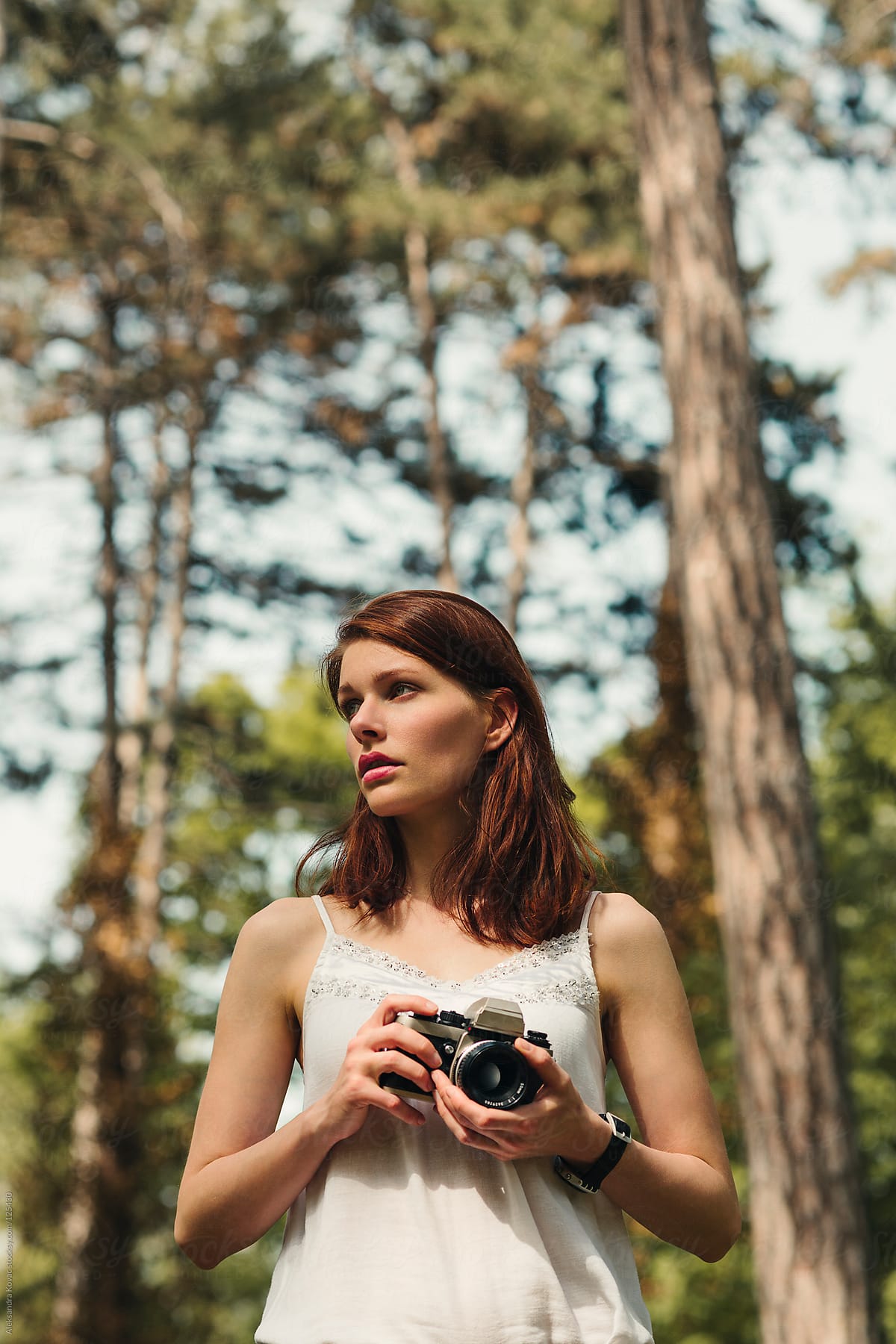 "Woman Holding A Camera In The Forest" by Stocksy Contributor ...