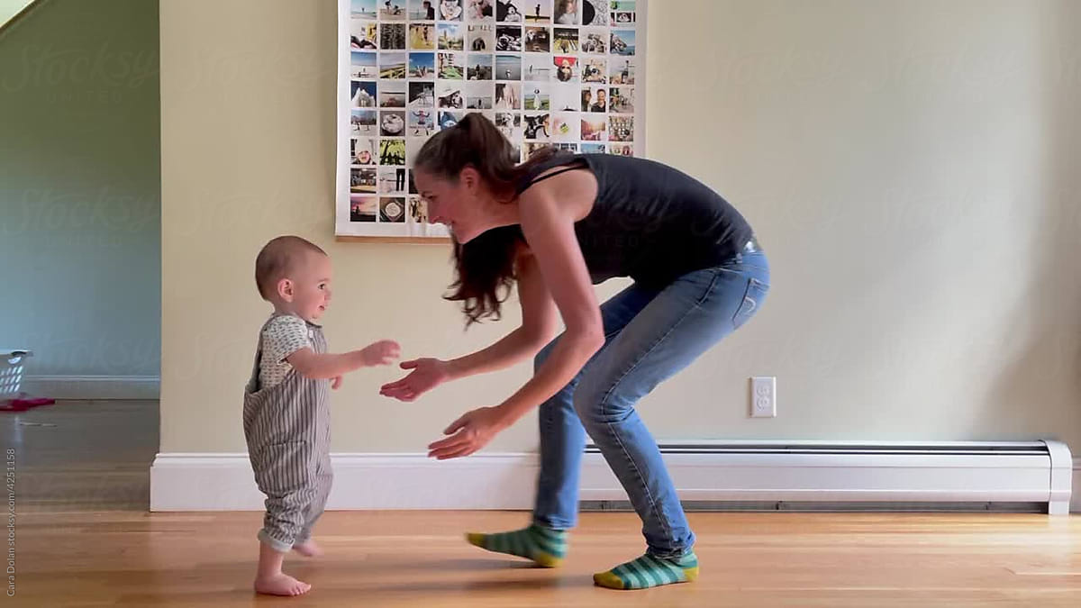 "Baby Taking First Steps With His Mom Cheering Him On" by Stocksy ...