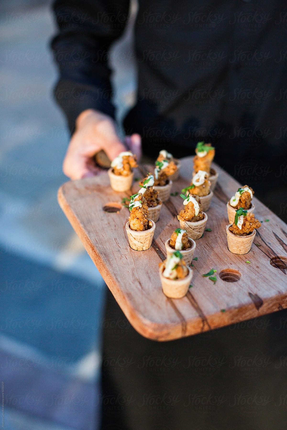 "Servers's Hands Holding Food At Event" by Stocksy Contributor "Andrew ...