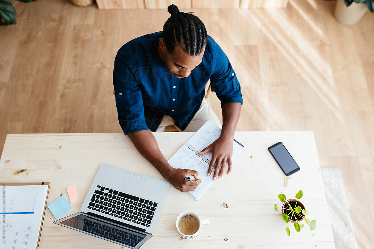 "Black Freelancer Making Notes At Table" by Stocksy Contributor ...