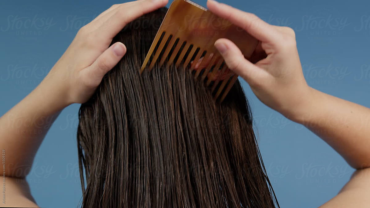 "Woman Brushing Wet Hair With Comb." by Stocksy Contributor "Artem ...