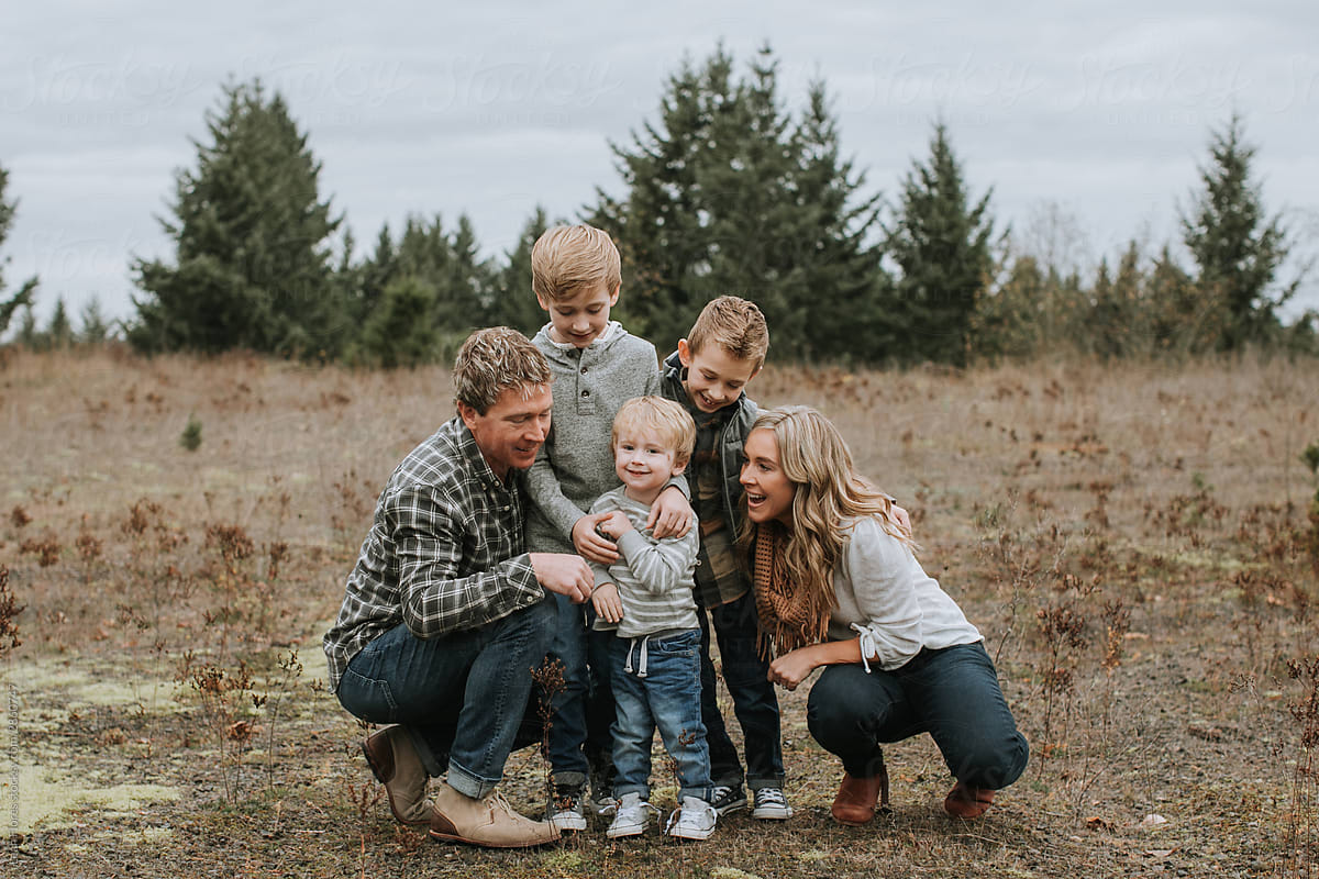 "Family Posed In Field" by Stocksy Contributor "Leah Flores" - Stocksy