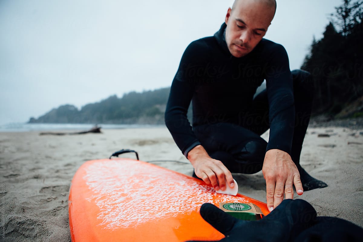 "Male Surfer Waxing His Surfboard" by Stocksy Contributor "Kristine ...