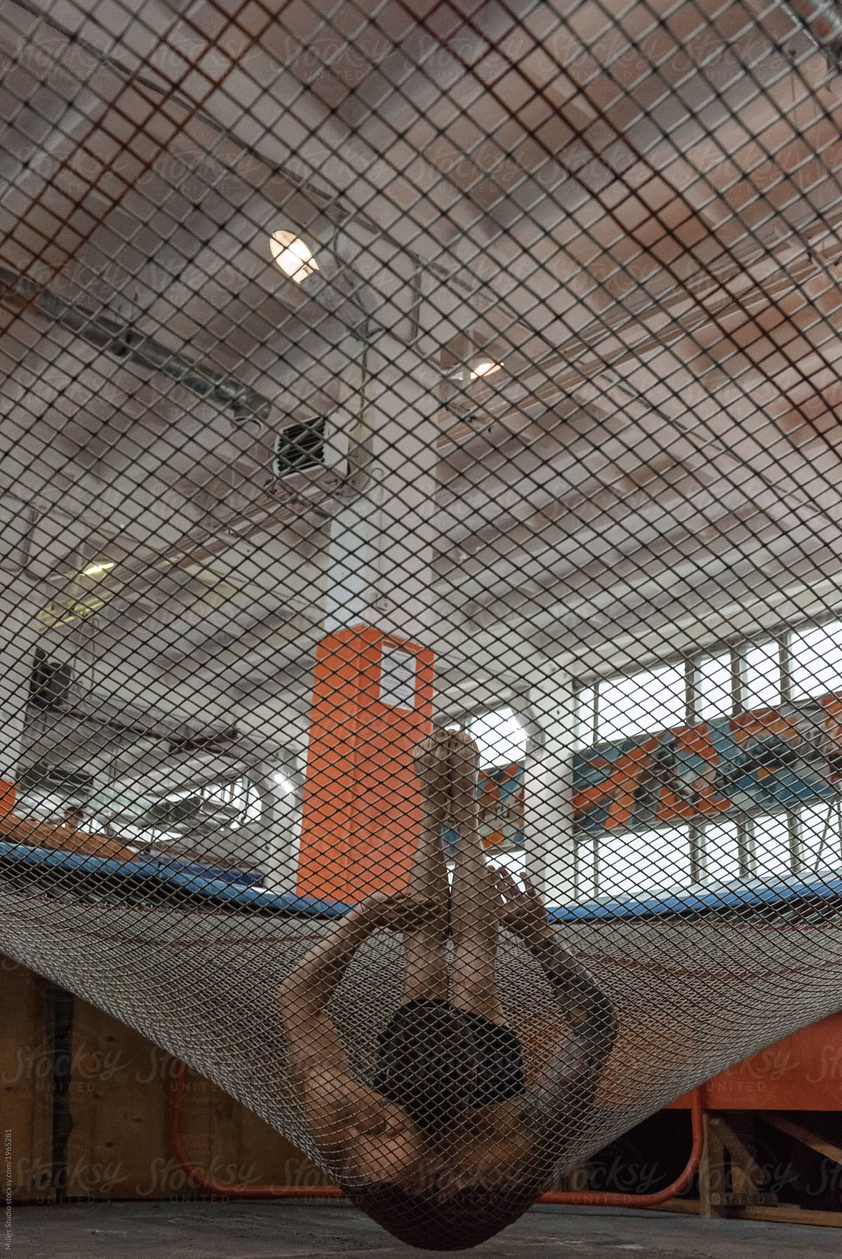 "Man Falling On Net Of Tramp" by Stocksy Contributor "Milles Team ...