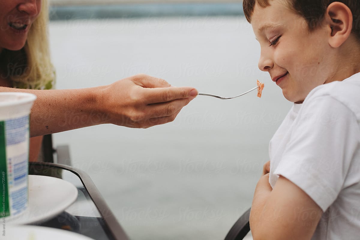 "Young Boy Resisting Food From Parent - Salmon On Fork" by Stocksy ...