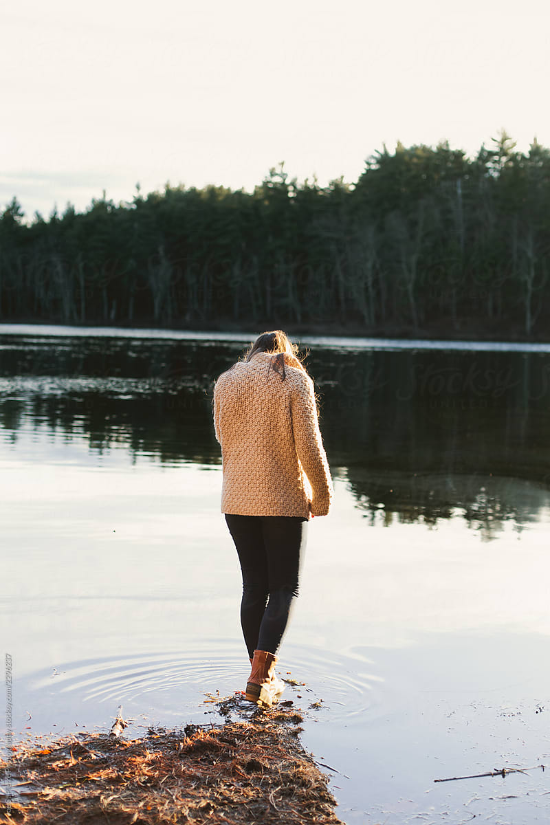 "Woman Walking Near Lake" by Stocksy Contributor "Joe St.Pierre" - Stocksy