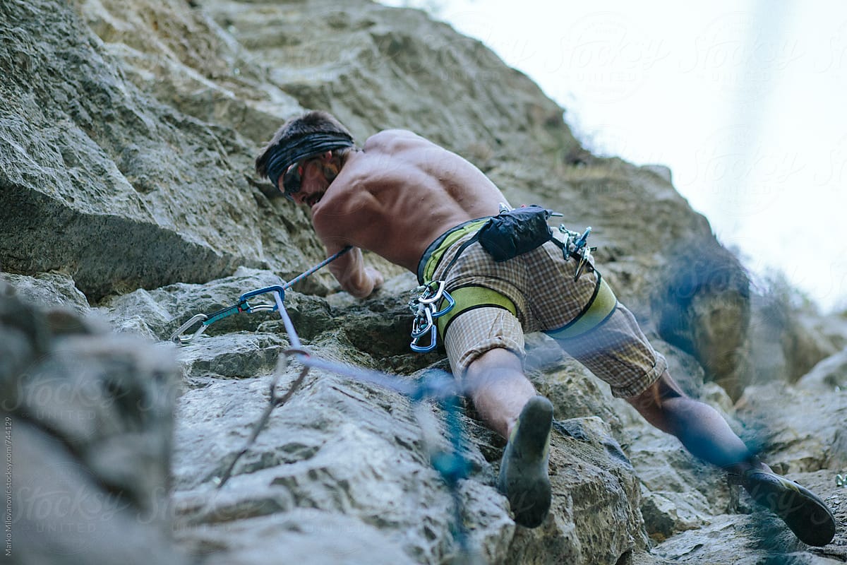 "Mountain Climber Hanging From A Rock" by Stocksy Contributor "Marko ...