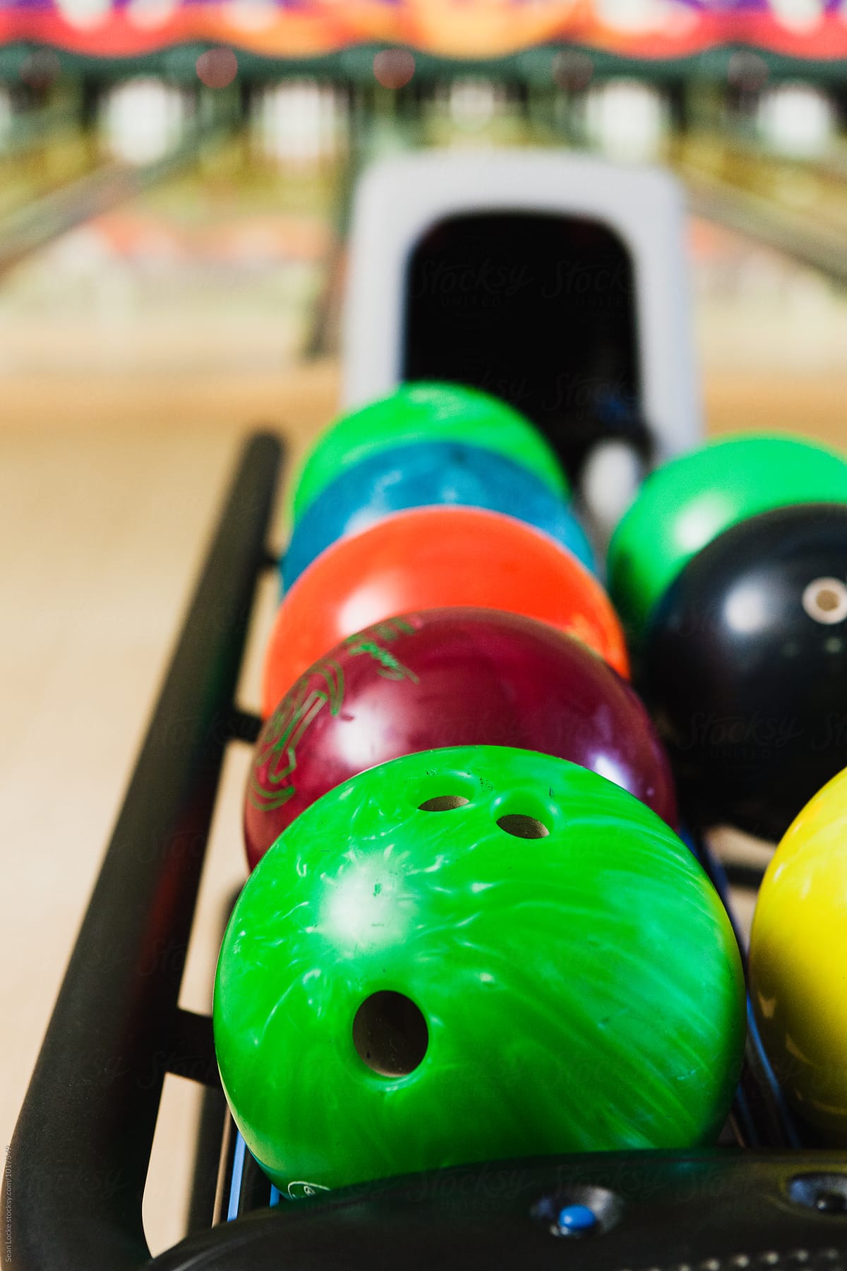 "Bowling: Many Balls Wait In The Return" by Stocksy Contributor "Sean ...