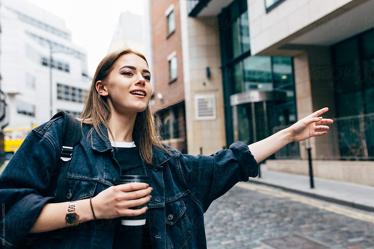 "Young Woman Stopping A TAxi On The Street" by Stocksy Contributor ...