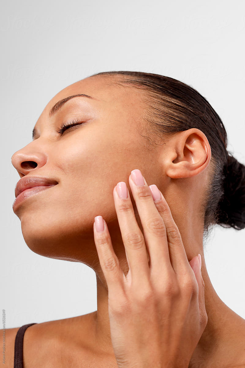 "Woman Gently Touching Her Face And Neck" by Stocksy Contributor "Artem ...