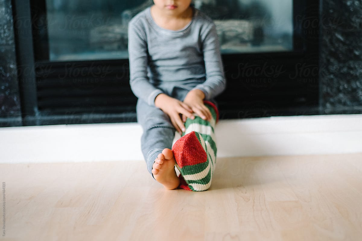 "Child Wears Christmas Stockings" by Stocksy Contributor "Tara ...