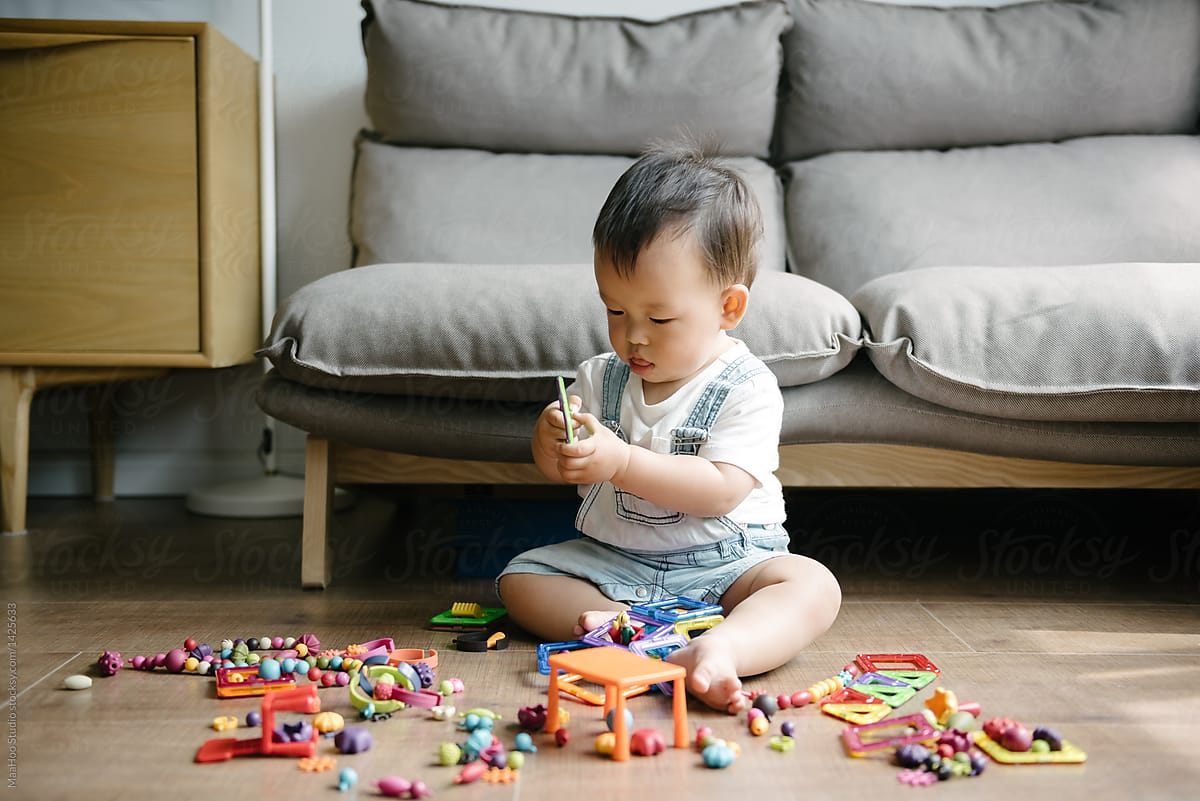 "Baby Boy Playing With Toy At Home" by Stocksy Contributor "MaaHoo ...