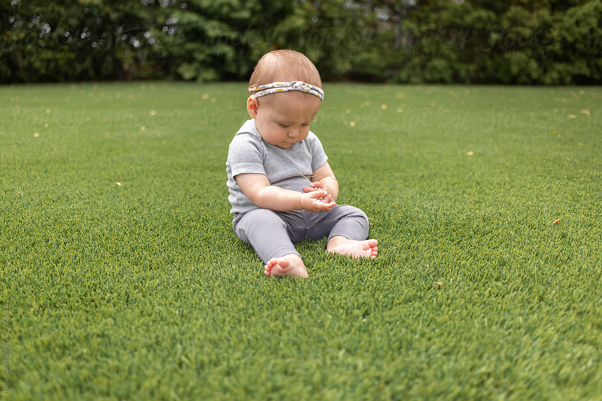 "Baby Girl On Grass" by Stocksy Contributor "Hannah Garvin" - Stocksy