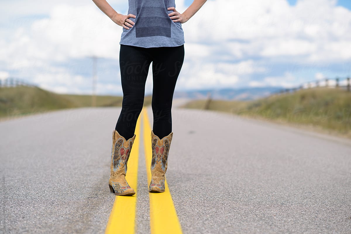"Woman Stands In The Middle Of A Road With Hands On Her Hips" by ...