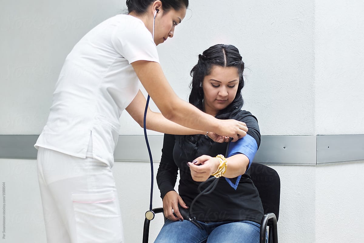 "Nurse Checks Patient's Blood Pressure" by Stocksy Contributor "PER ...
