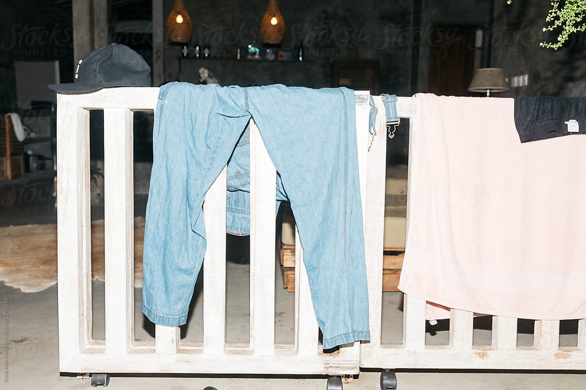 "Wet Overall Clothes Drying On Rack After Getting In Pool" by Stocksy ...