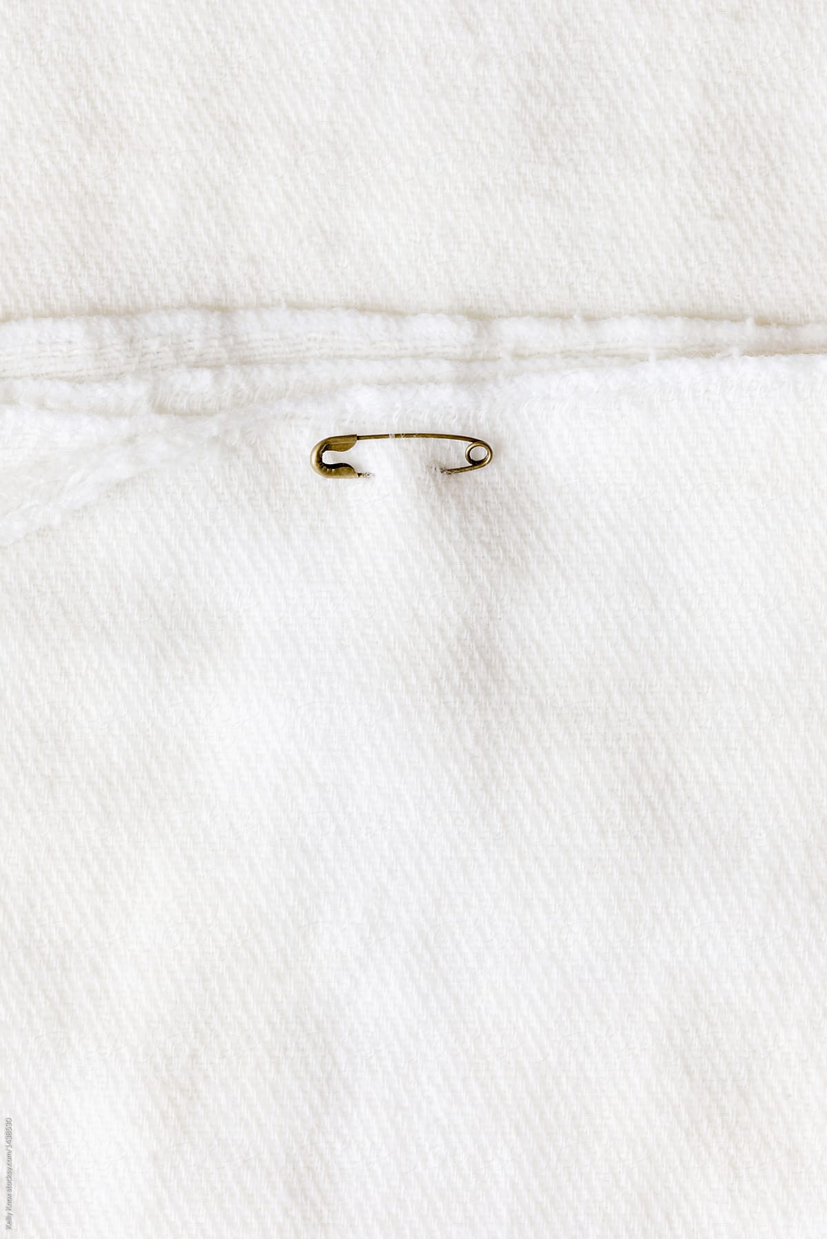 "Small Safety Pin Holding Together Layers Of Fabric" by Stocksy ...