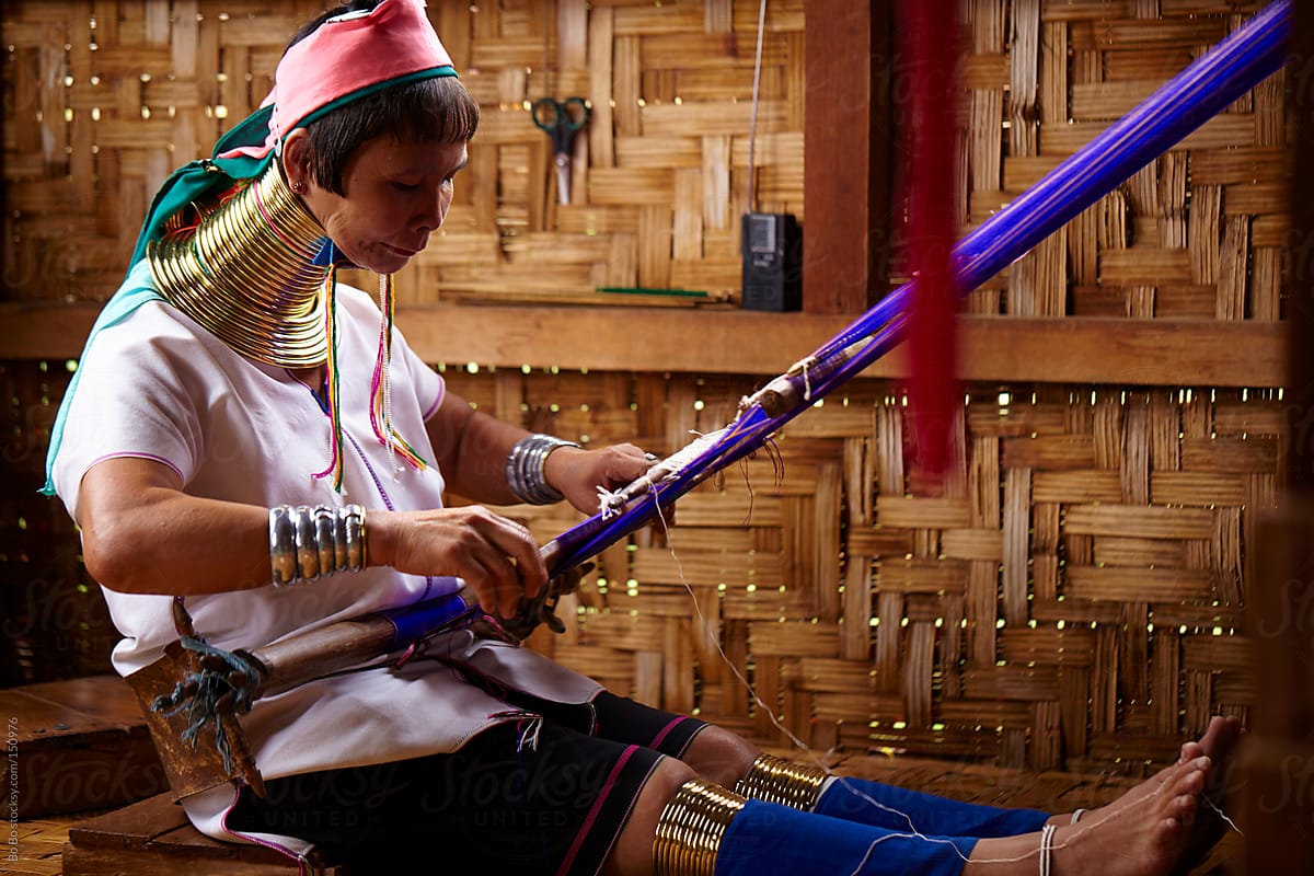 "Long Neck Woman Weaving" by Stocksy Contributor "Bo Bo" - Stocksy